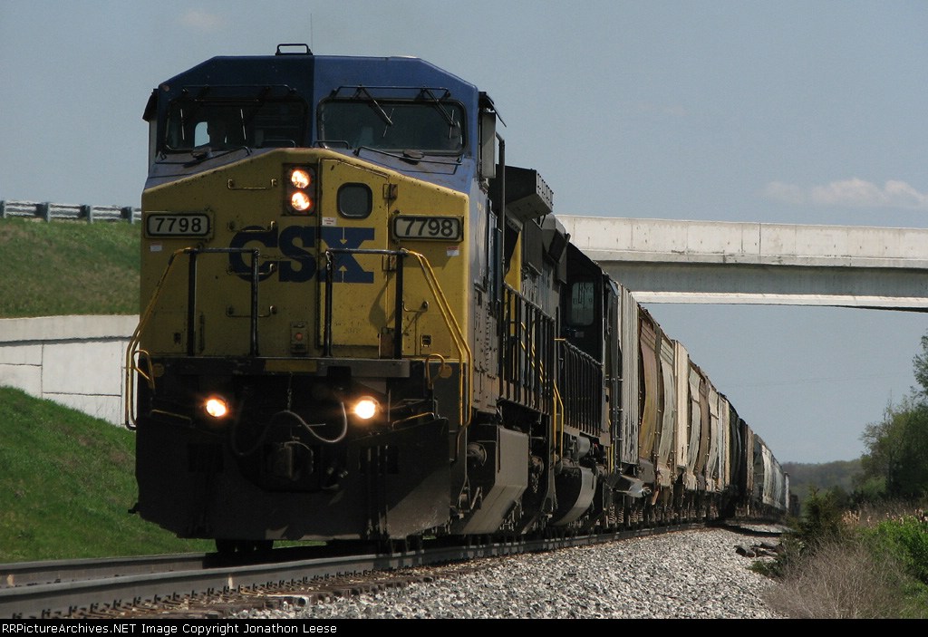 CSX 7798 leads Q335-04 westbound under the overpass